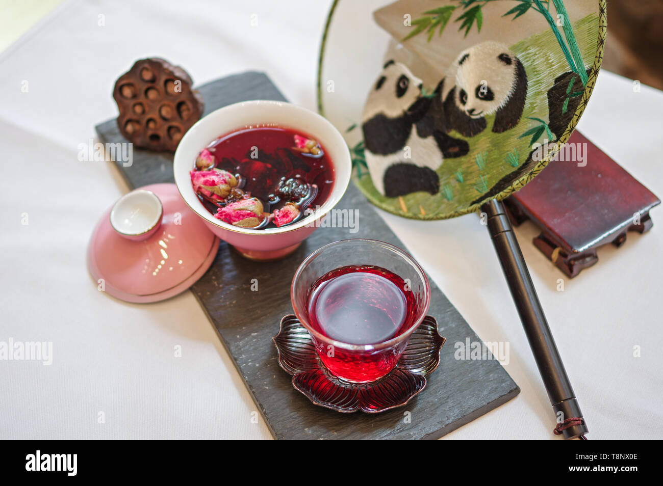 Scented tea in pink porcelain and glass cup decorated with lotus and ...