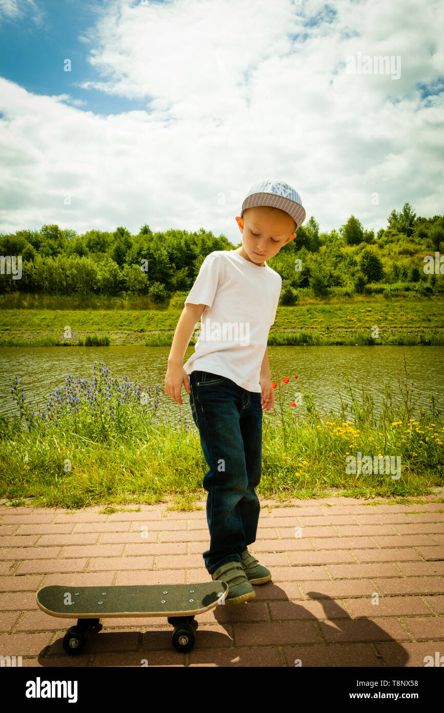 Active childhood. Little man skateboarding. Skater boy child kid with ...