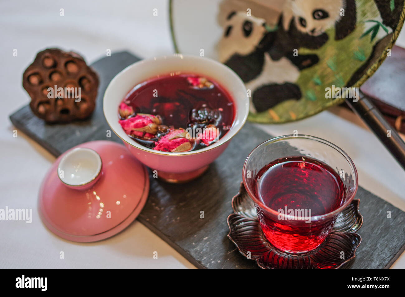 Scented tea in pink porcelain and glass cup decorated with lotus and ...
