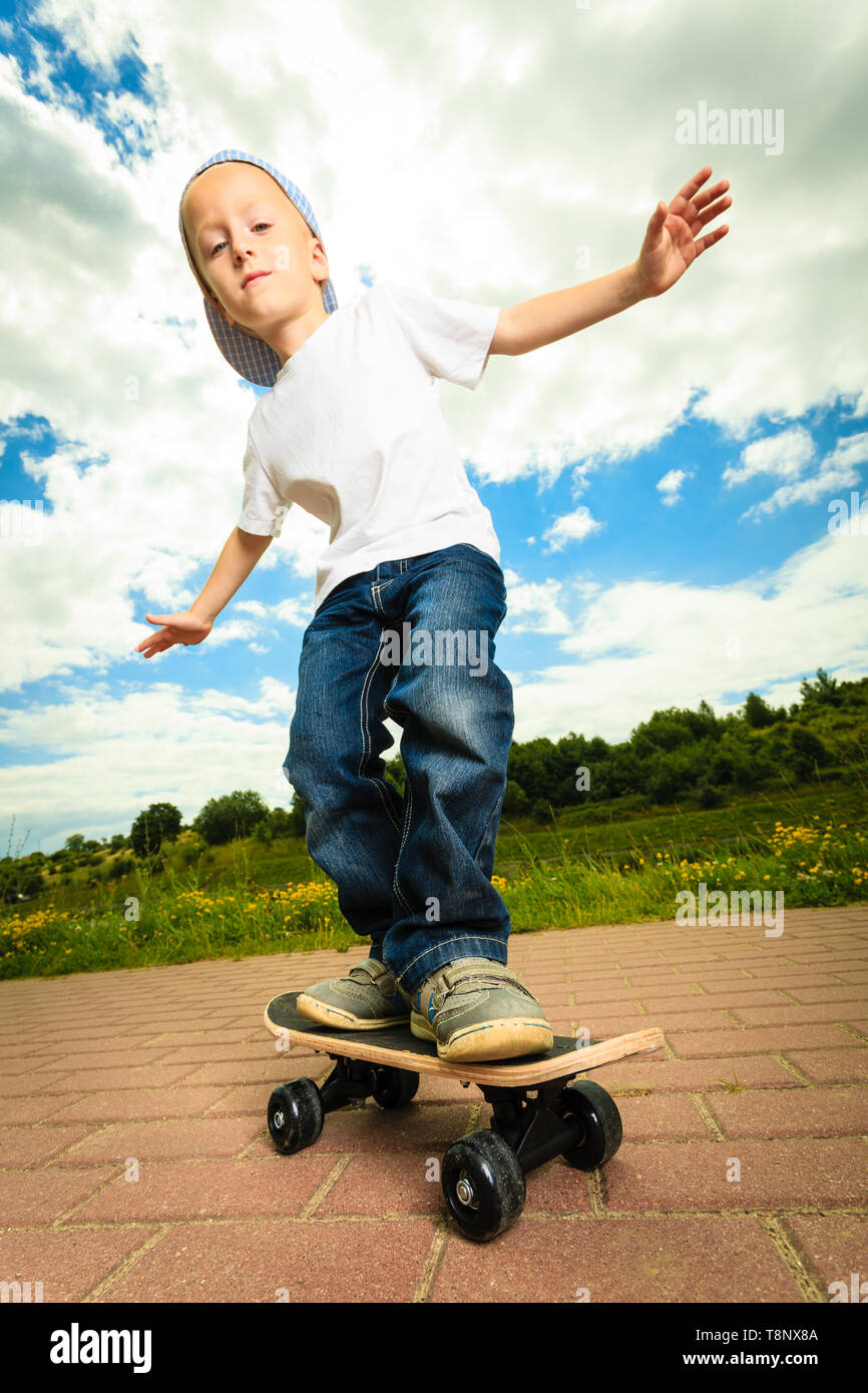 Active childhood. Little man skateboarding. Skater boy child kid with ...