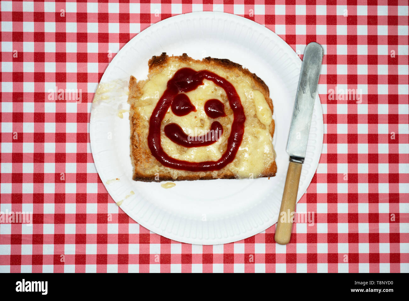 Cheese on toast with tomato ketchup smiley face Stock Photo - Alamy