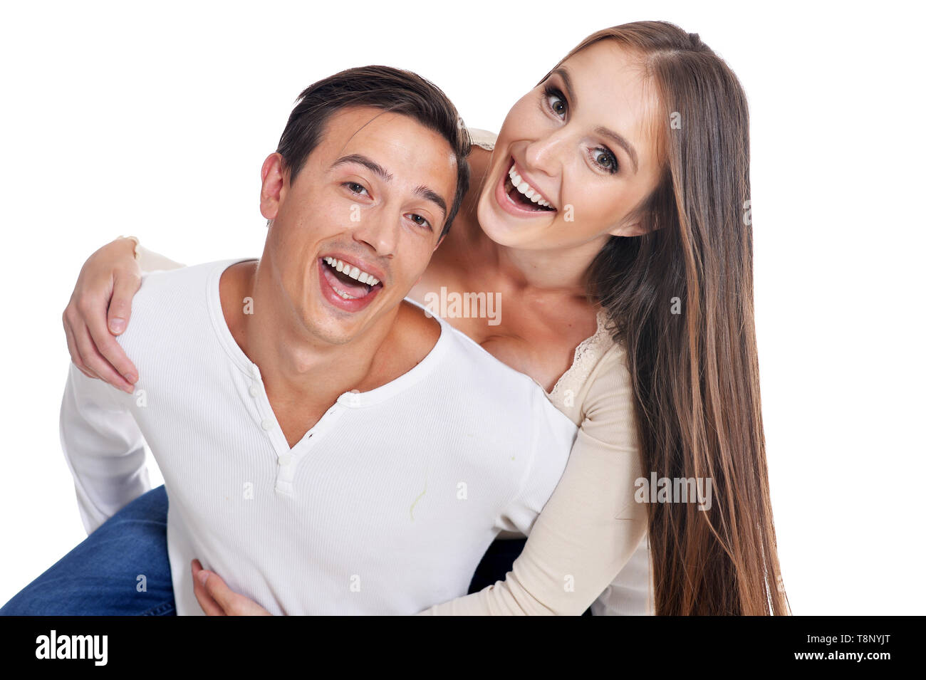 Happy young couple posing isolated on white background Stock Photo - Alamy