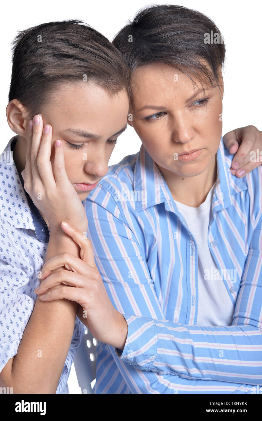 Sad beautiful family posing on a white background Stock Photo - Alamy