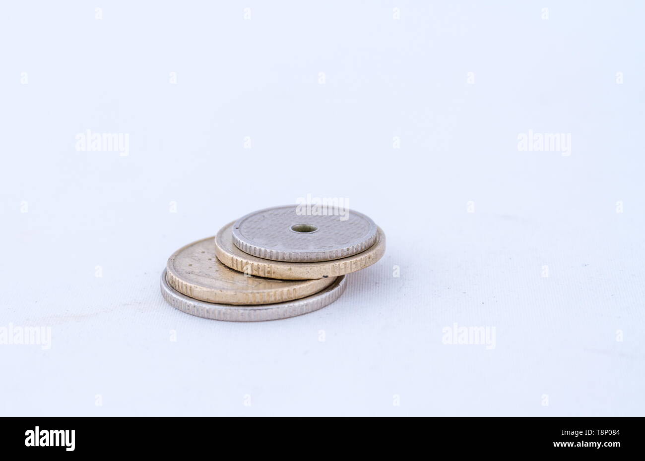 A small stack of coins isolated on a white background image with copy ...