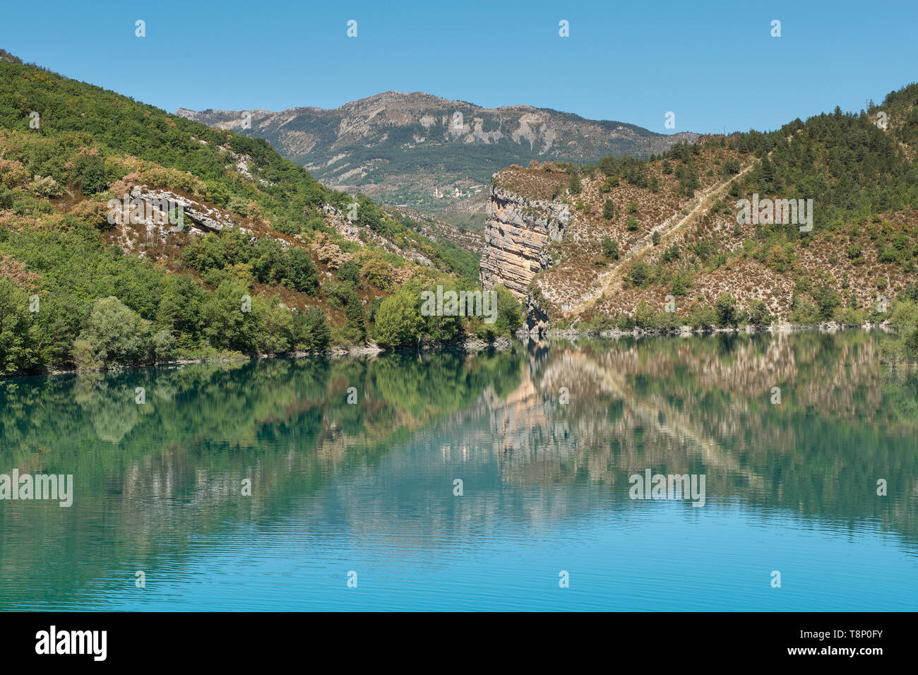 Lake of Castillon, a lake with mountains and green hills with a blue ...