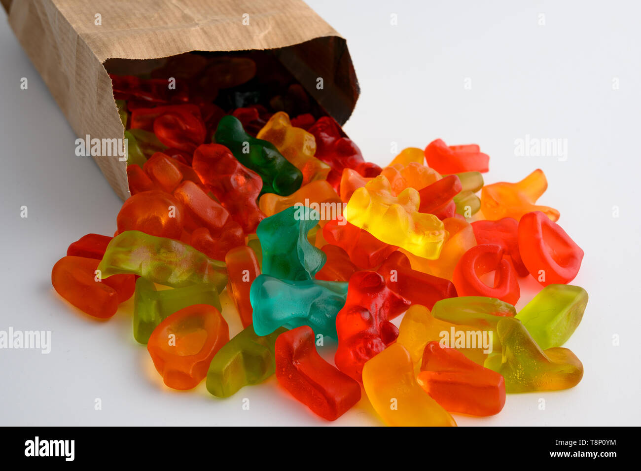 Paper bag of colorful gummy candies on white background Stock Photo - Alamy