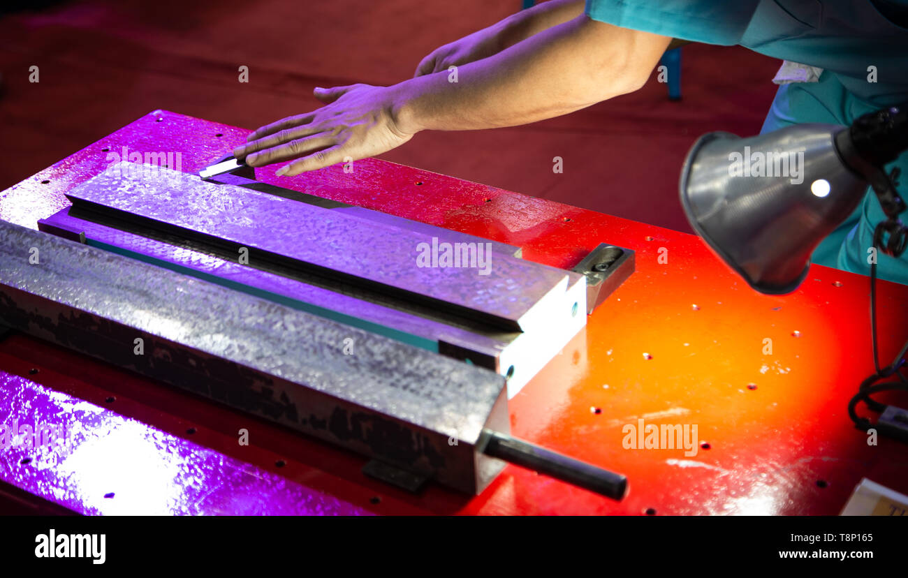 Worker perform hand scraping slide way of the old bed machine Stock ...