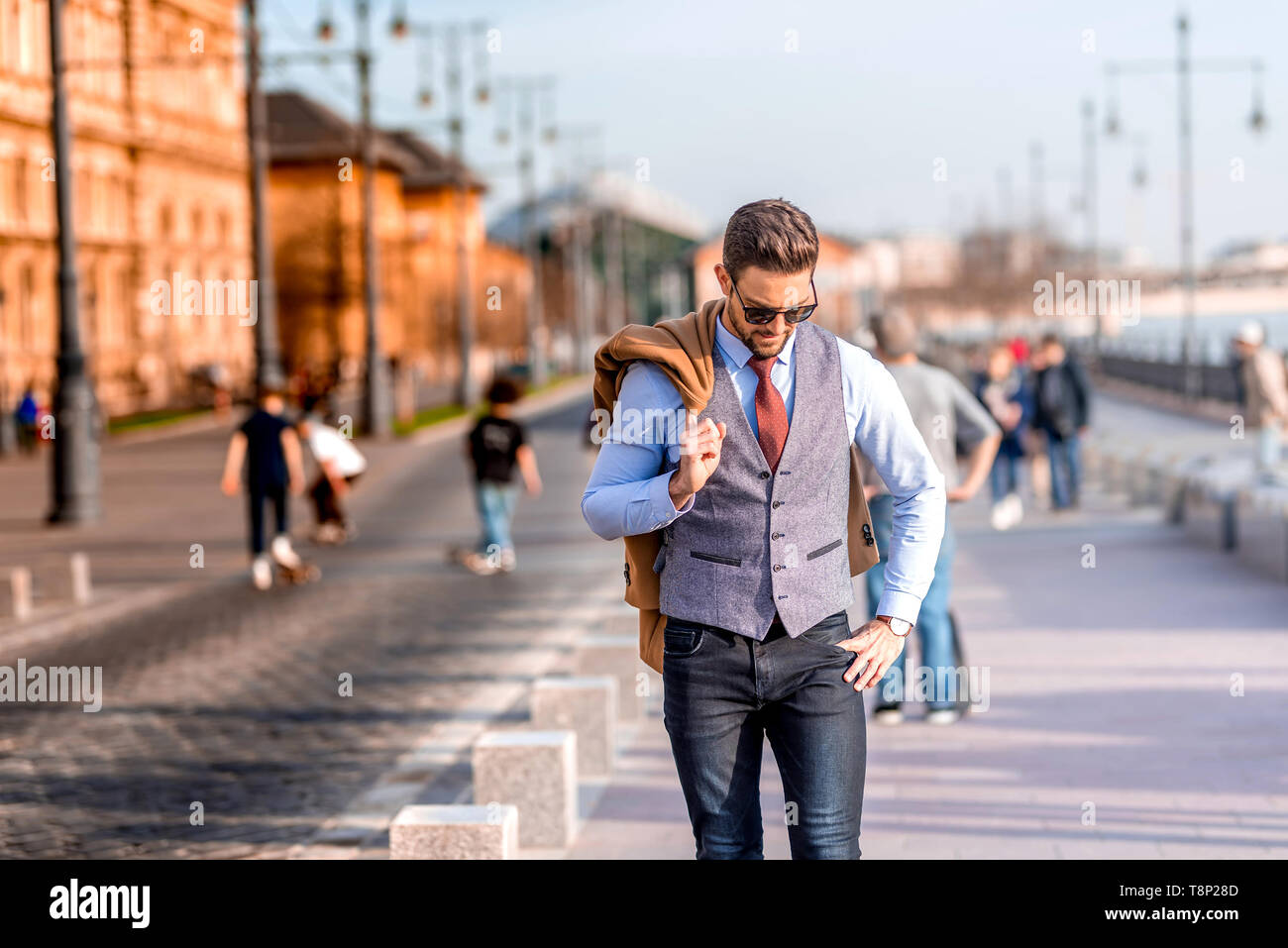 A handsome elegant man walking on the streets on a sunny day Stock ...