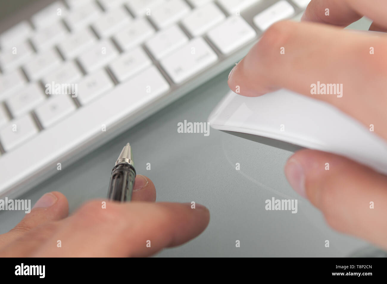 An office worker business person working at a desk using a mouse and ...
