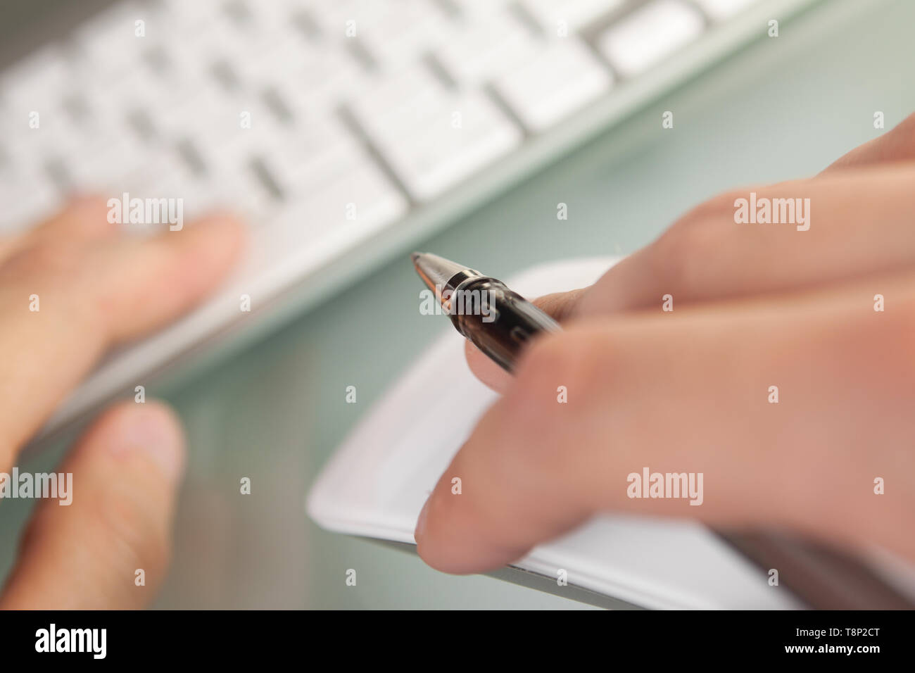An office worker business person working at a desk using a mouse and ...
