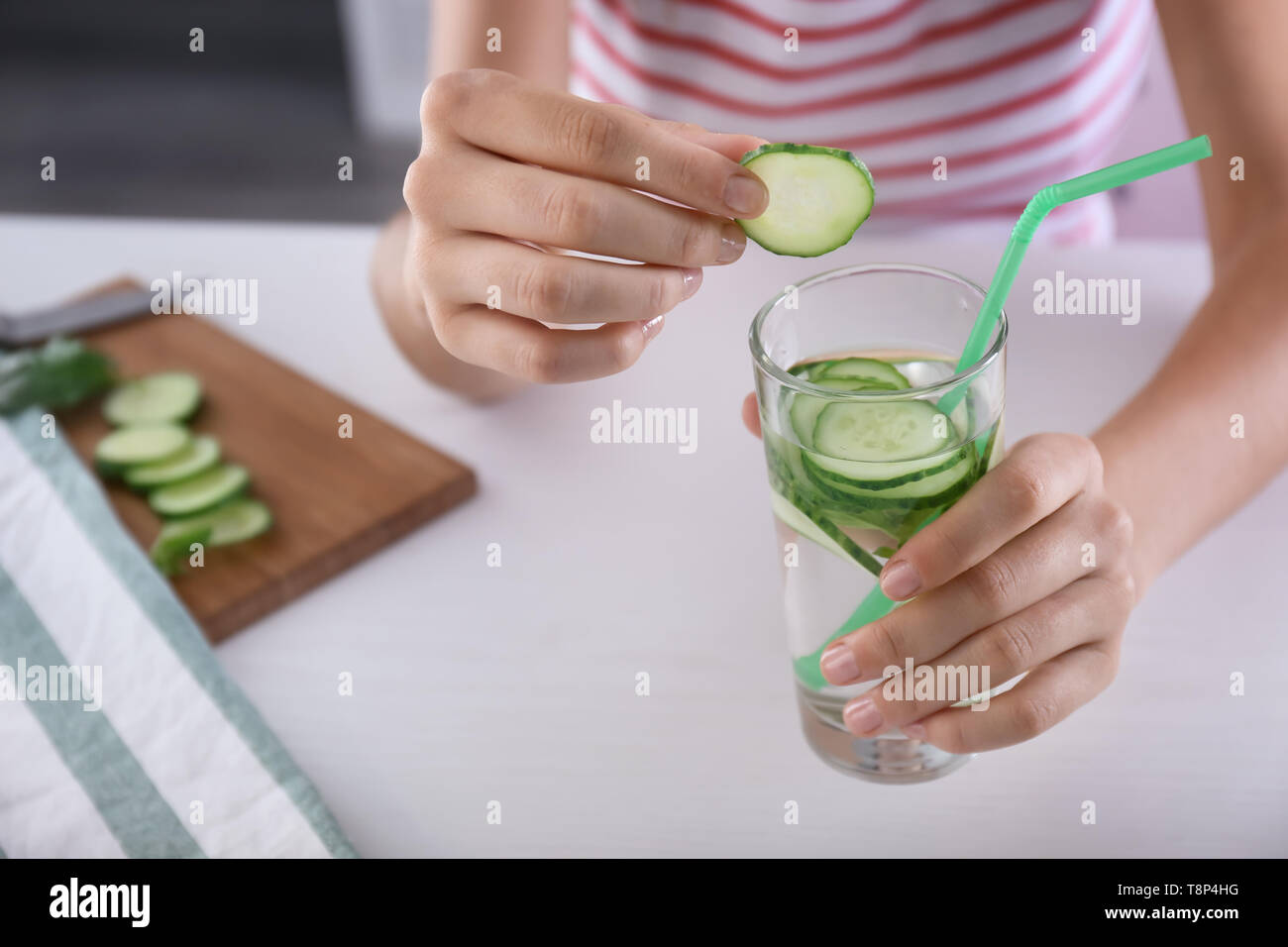 Woman putting cucumber glass hi-res stock photography and images - Alamy