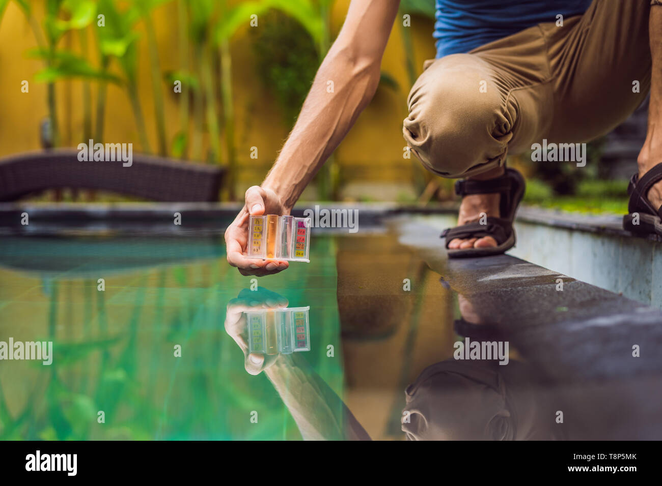 Pool worker checks the pool for safety. Measurement of chlorine and PH ...