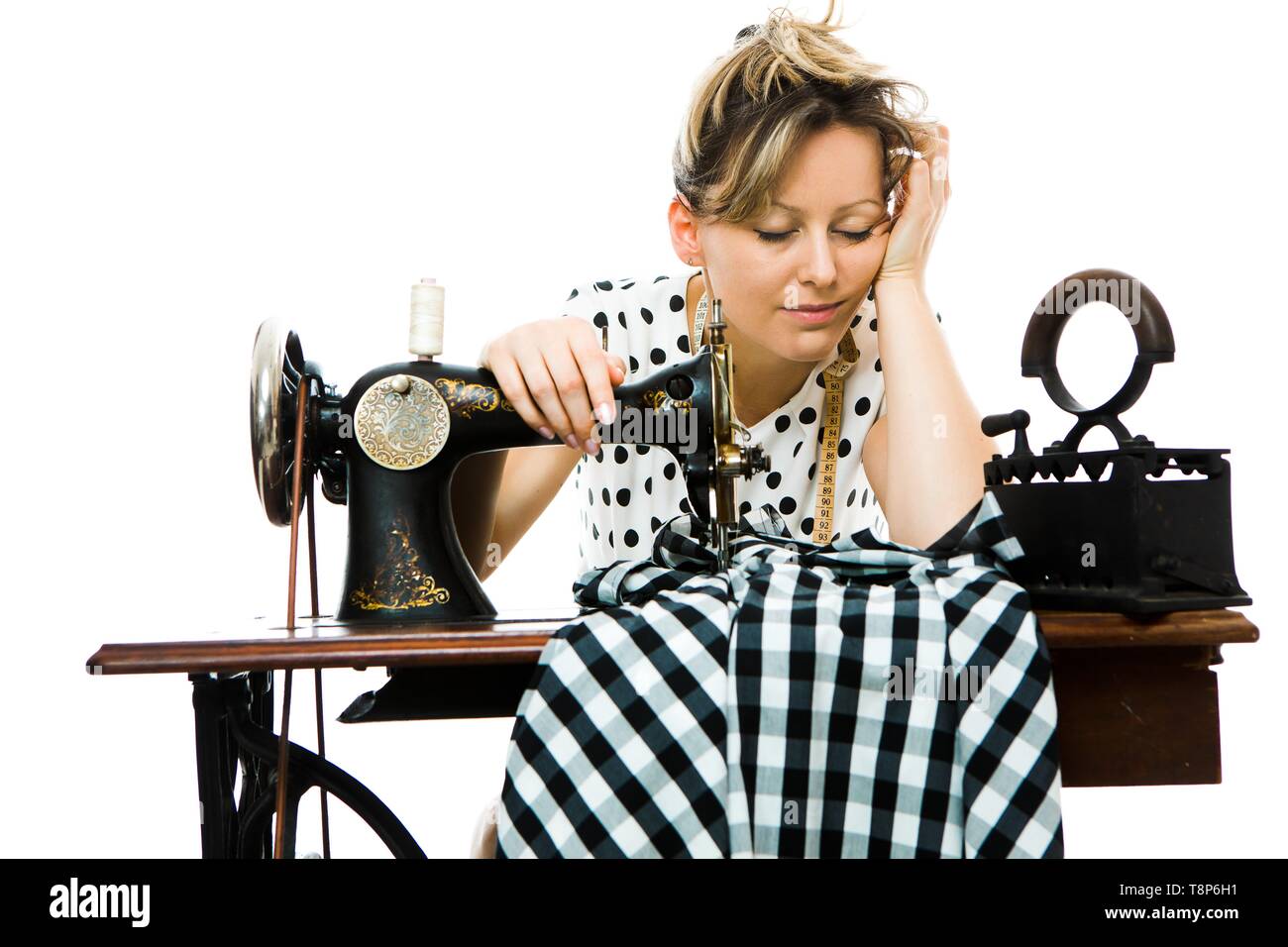 Tired woman dressmaker sleeps by sewing manual machine - overworked ...