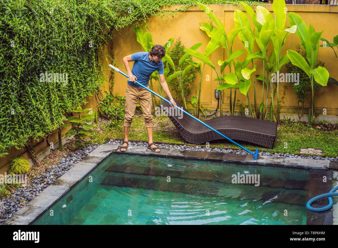 Young man cleaning swimming pool hi-res stock photography and images ...