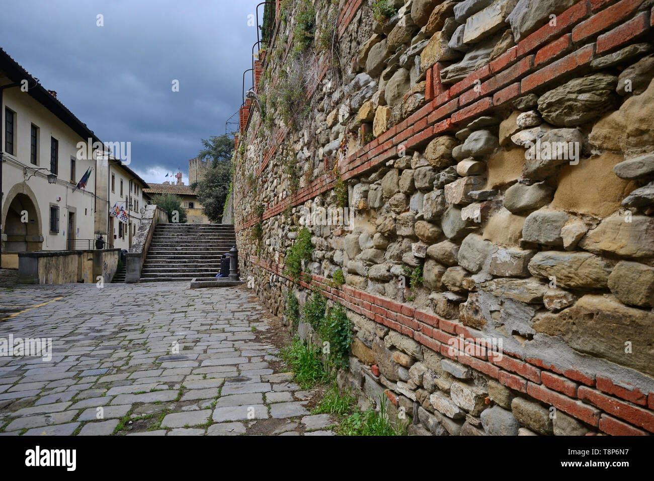 Typical street view in Arezzo historic center with its ancient wall and ...