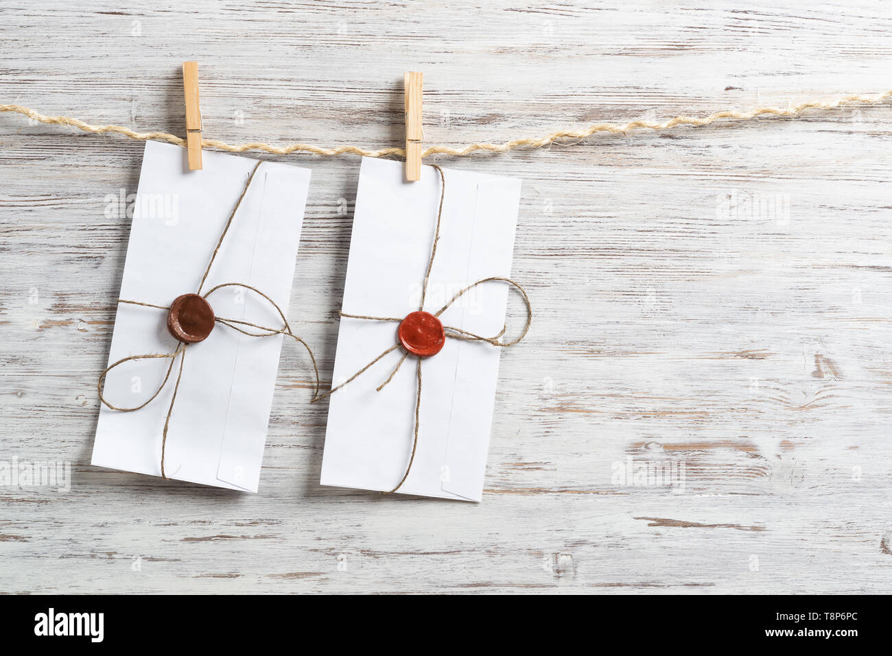 White envelopes hanging on rope Stock Photo - Alamy