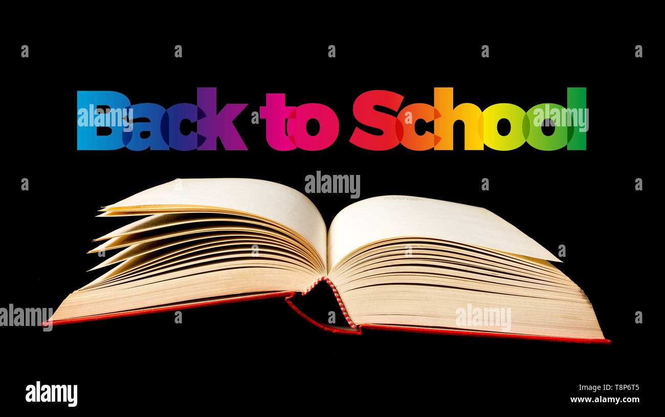 Back to school. Open book on black background. Text Stock Photo - Alamy