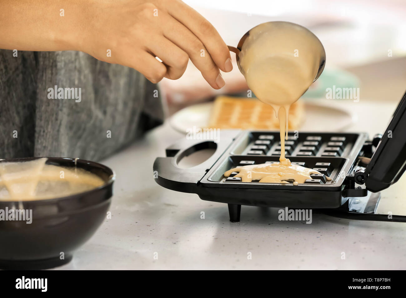 Woman cooking Belgian waffles Stock Photo - Alamy