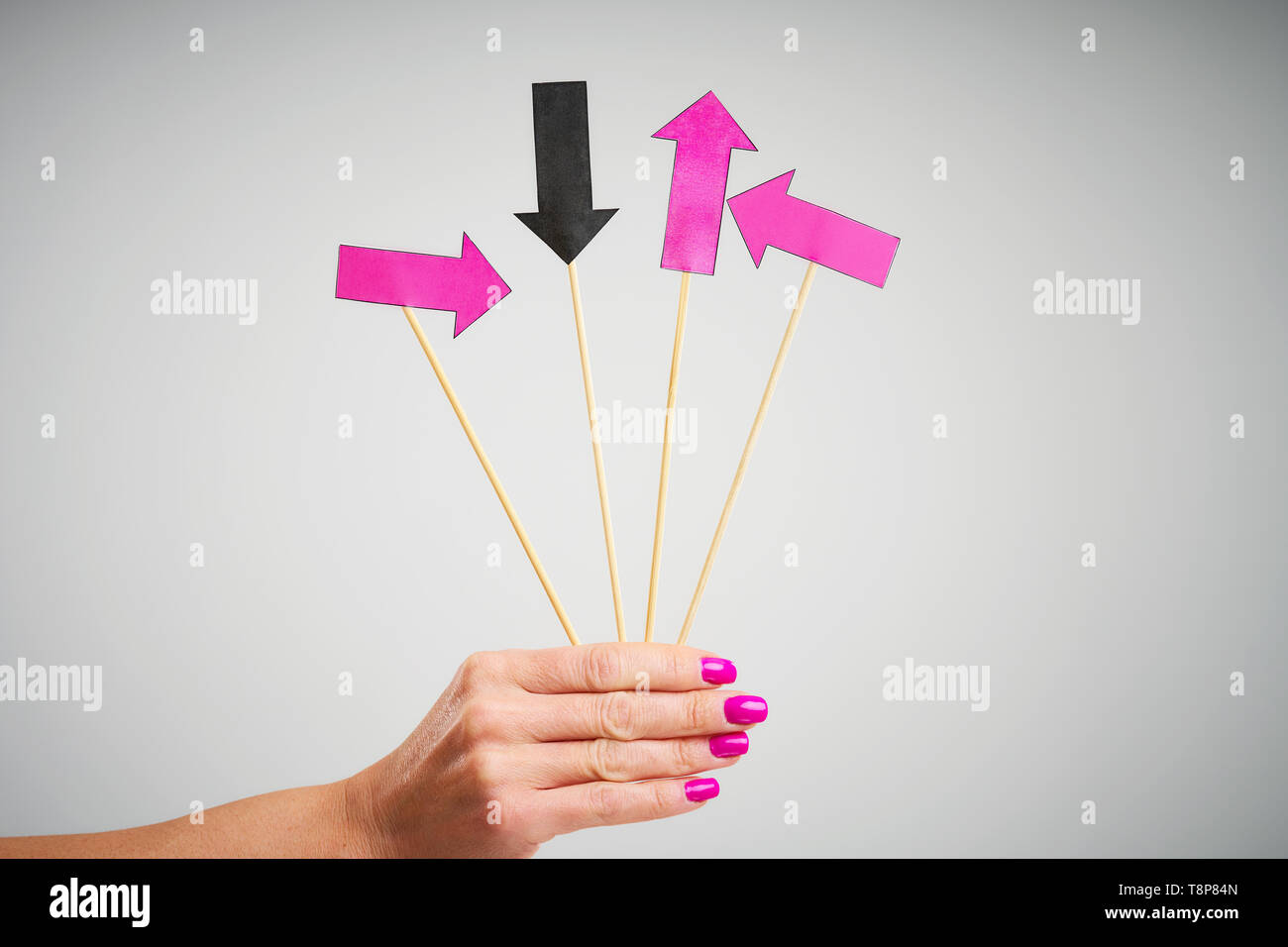 A picture of female hand holding arrows over grey background Stock ...
