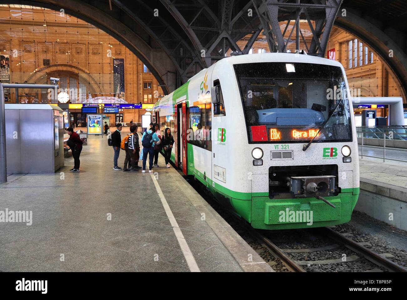 LEIPZIG, GERMANY - MAY 9, 2018: People board Erfurter Bahn train at the ...