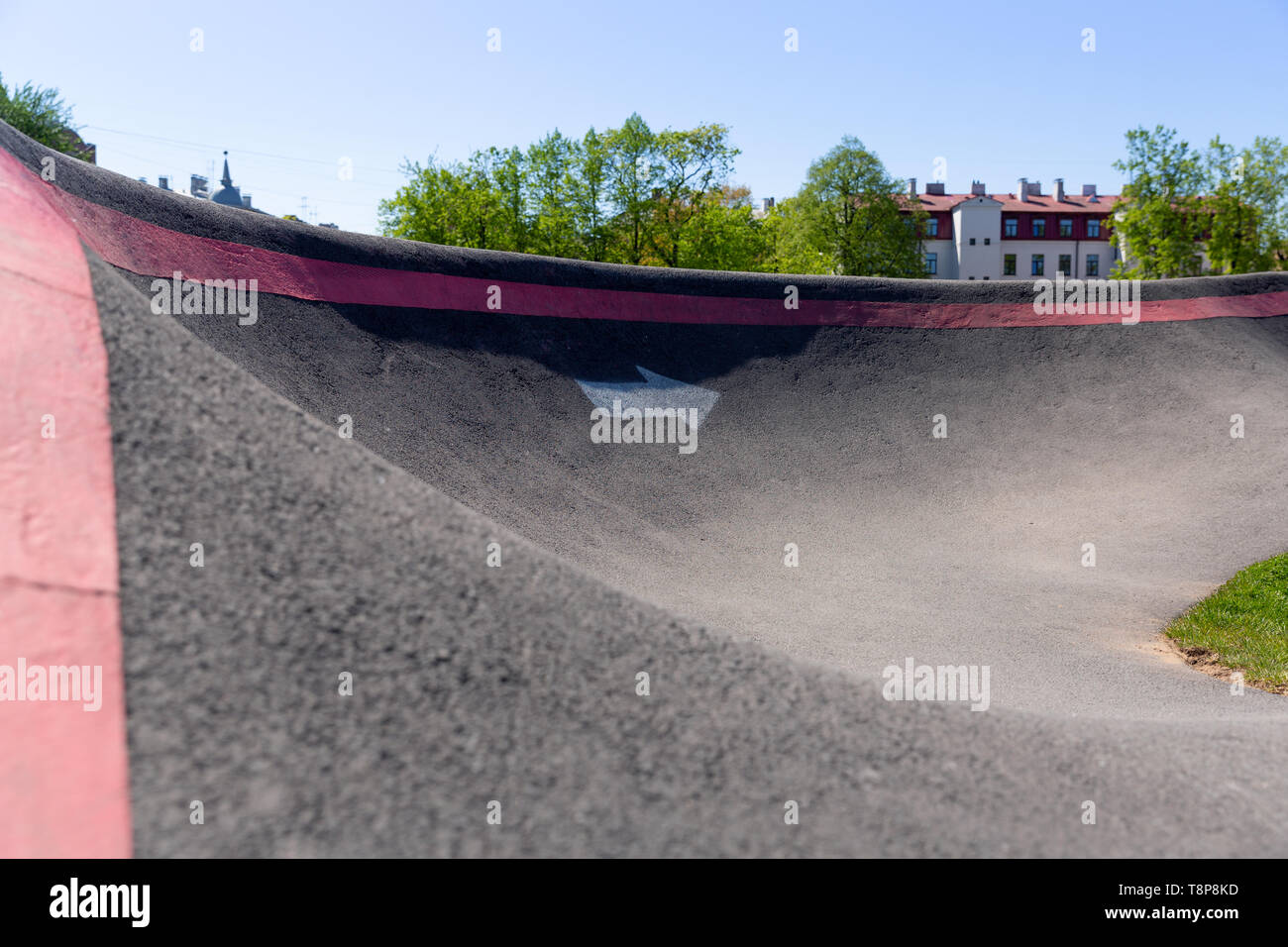Bike and skate playground at city center. Houses and bmx cycling track ...
