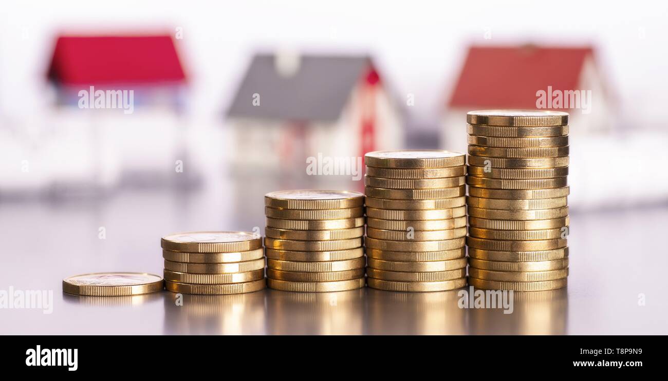 Rising stacks of coins with houses in the background | usage worldwide ...
