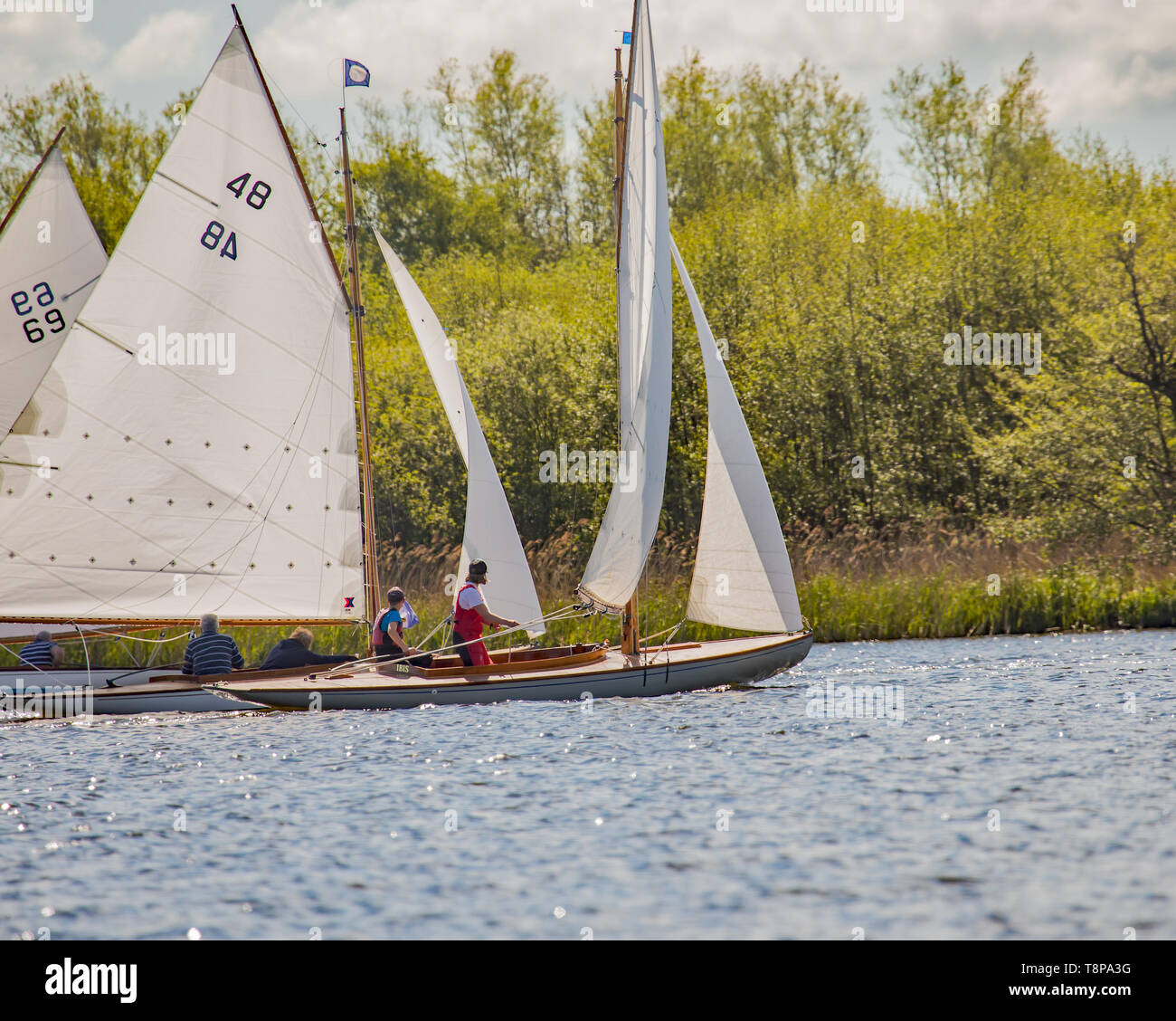 Sail boat racing gala on Wroxham Broad, Norfolk. Brown boats running ...