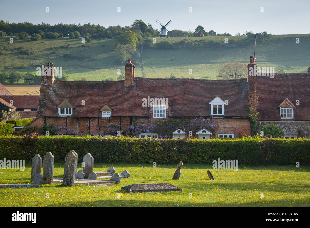 Period cottages in Turville viewed from across the churchyard with ...