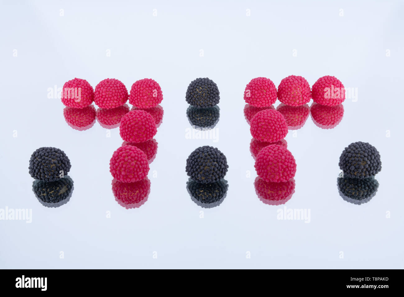 two colors of candies in a line Stock Photo - Alamy