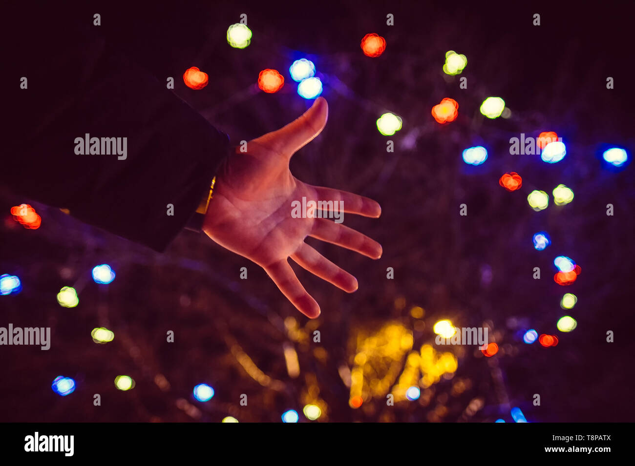 Closeup hand in the lights of the night city Stock Photo - Alamy