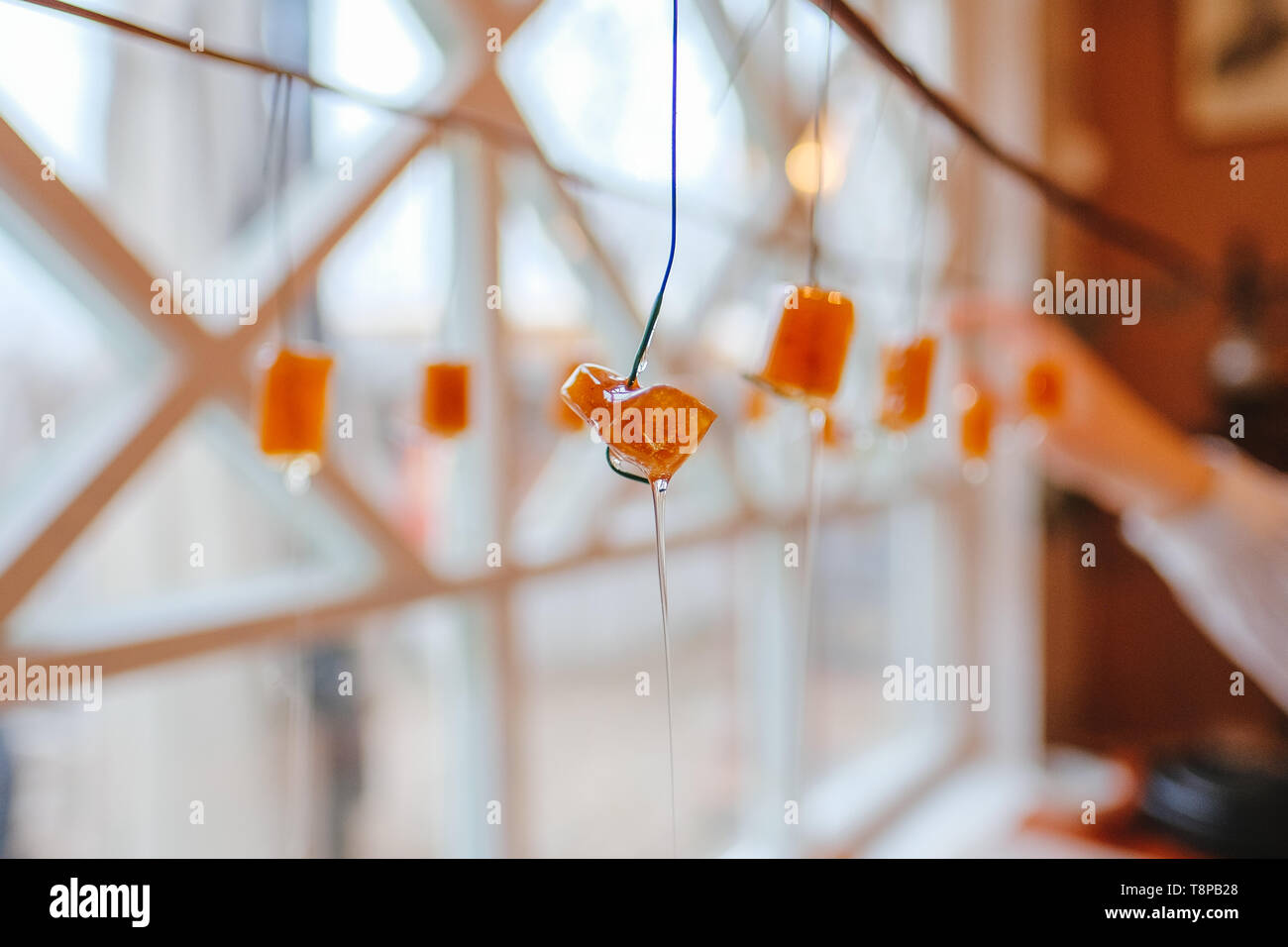 candies in caramel. cooking sweets at the factory, handmade Stock Photo ...
