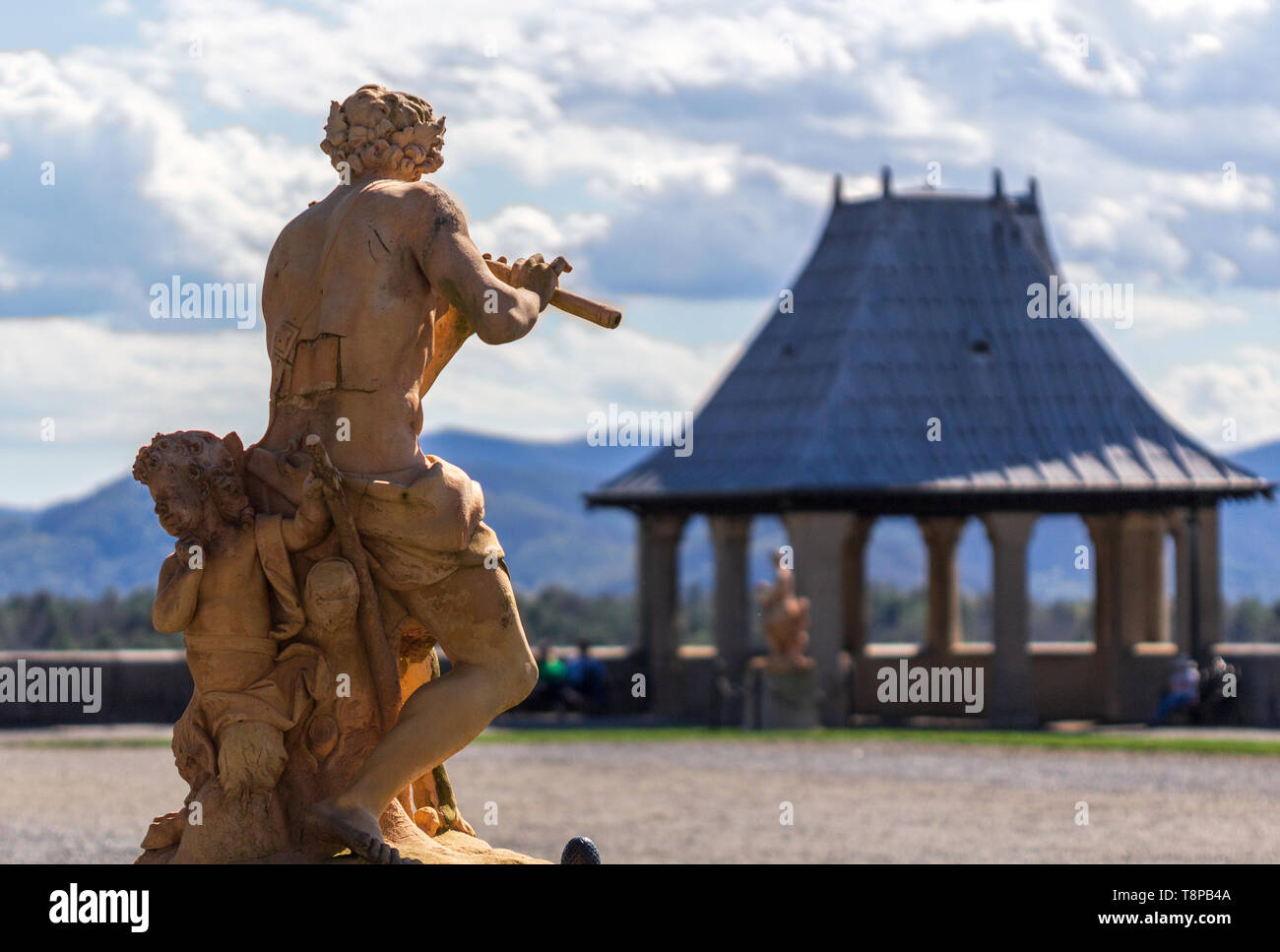 A 17th century terra cotta sculpture of Pan plays the flute facing the ...
