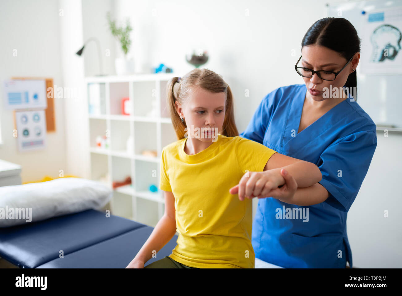 Concentrated dark-haired professional doctor being concerned with state ...
