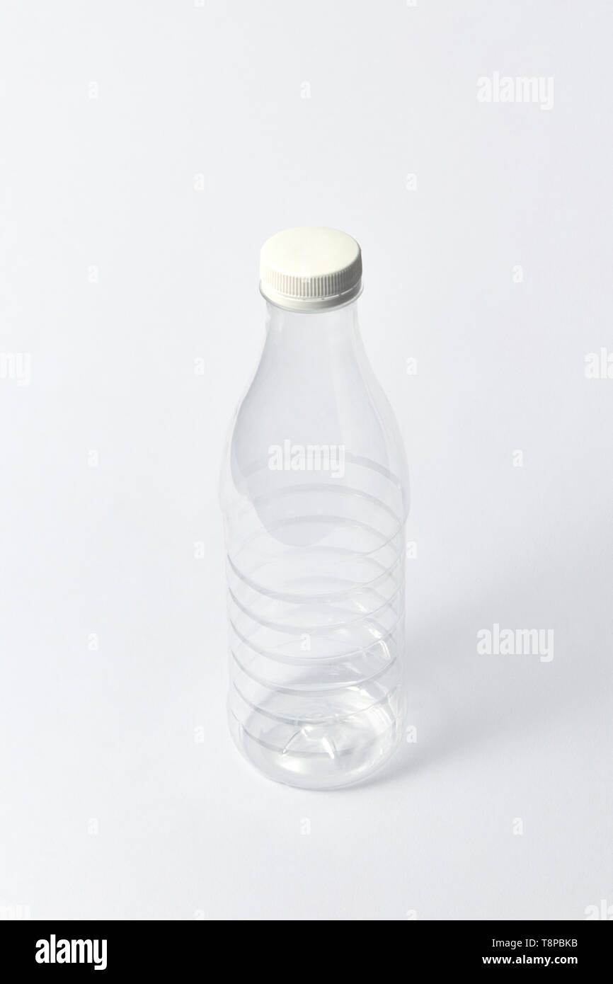 Transparent empty bottle for liquid on a light background. Mock up ...