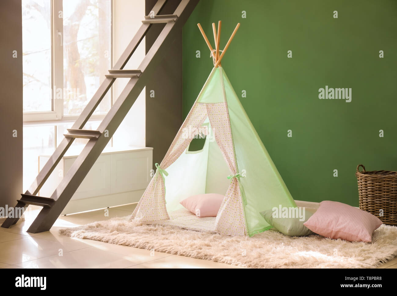 Cozy play tent for kids near color wall Stock Photo - Alamy