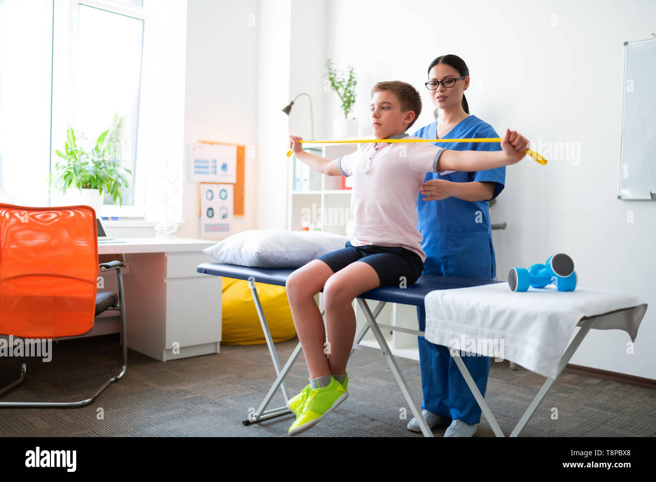 Resolute short-haired young boy using special sportive equipment Stock ...