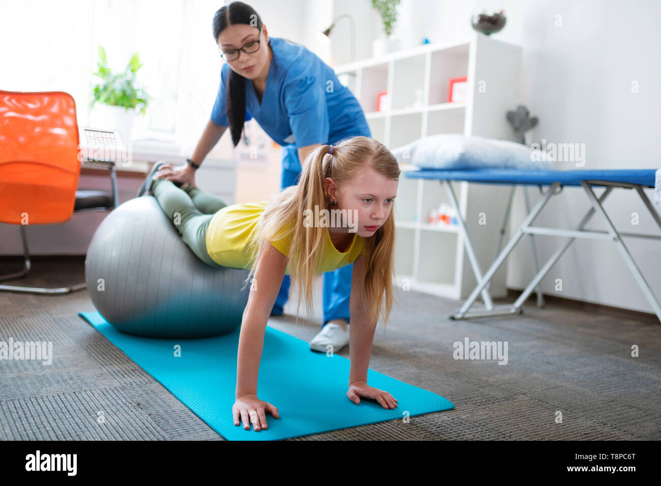 Calm long-haired girl with two ponytails wearing comfortable clothes ...