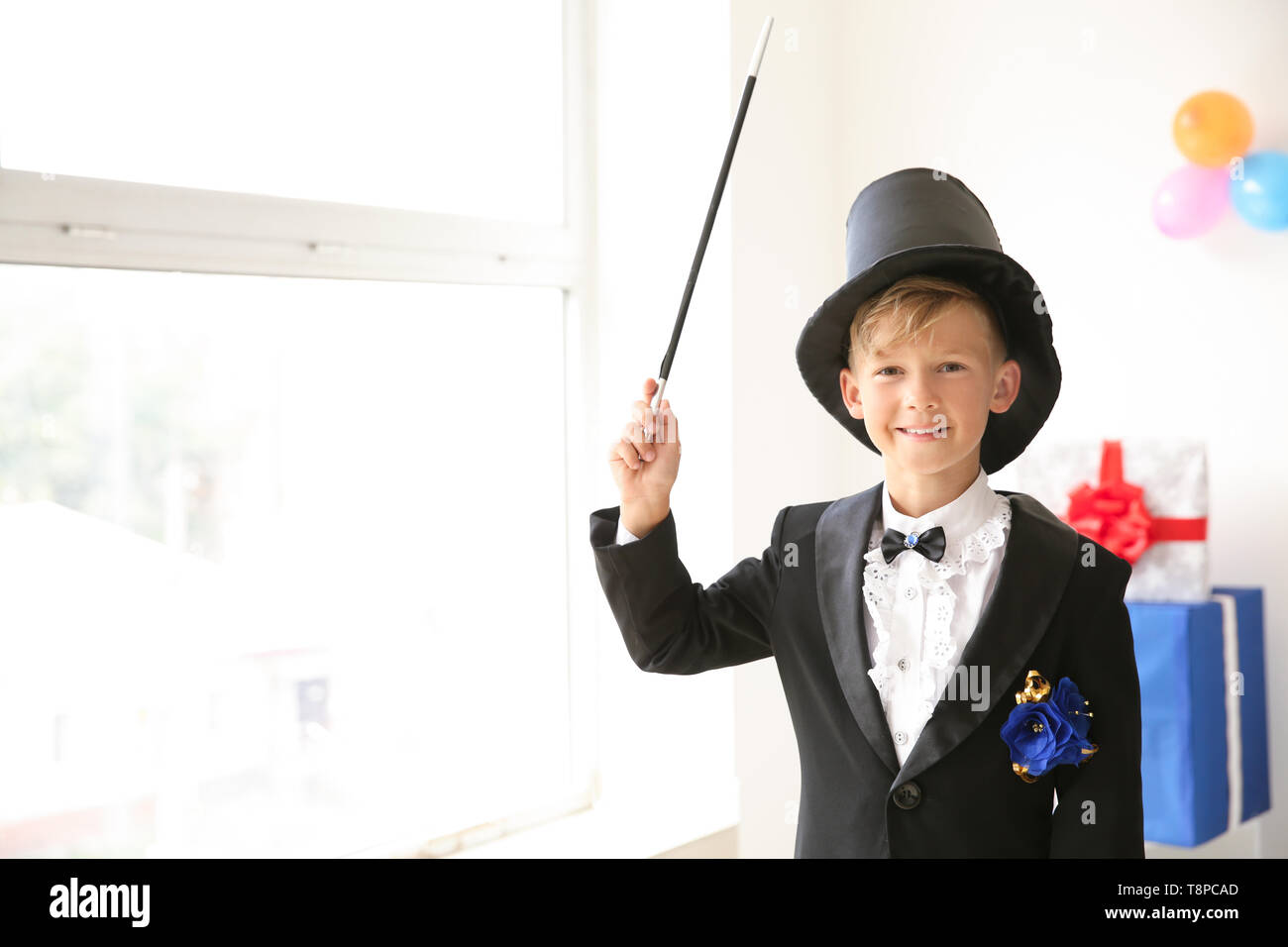 Cute little magician indoors Stock Photo - Alamy