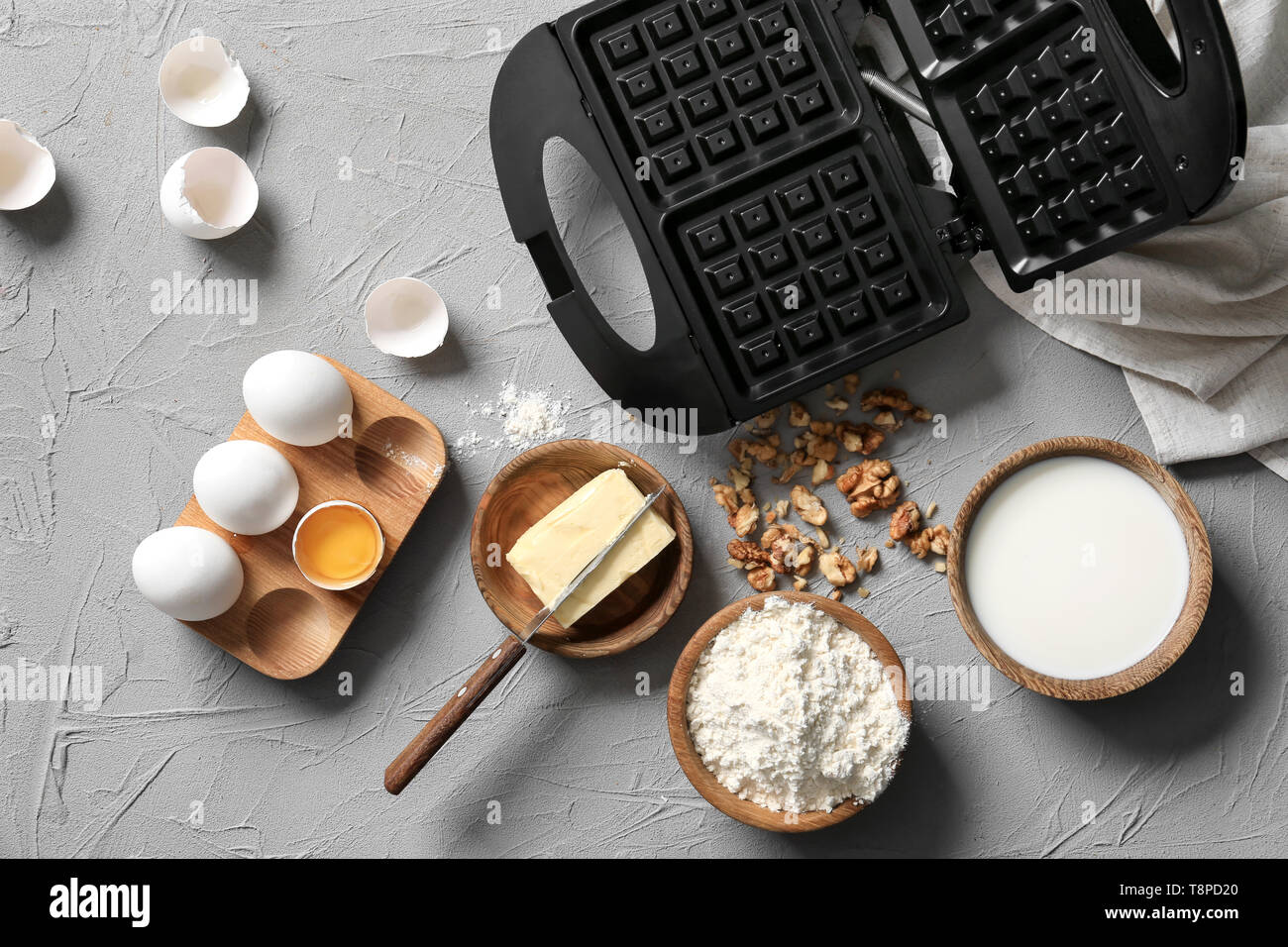 Modern waffle maker with ingredients on grey table Stock Photo - Alamy