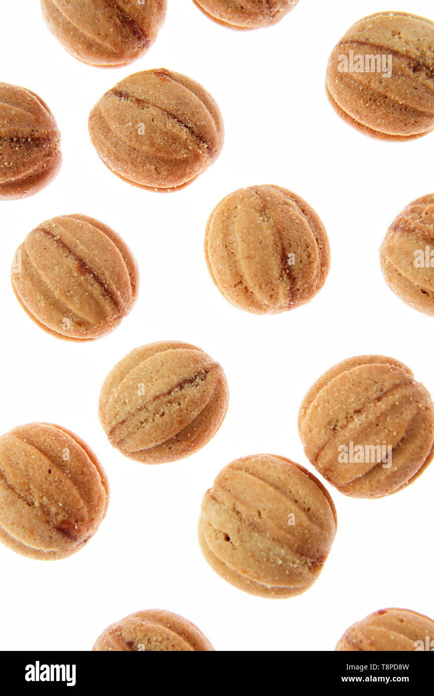 Fresh cakes walnuts pattern on a white background Stock Photo - Alamy
