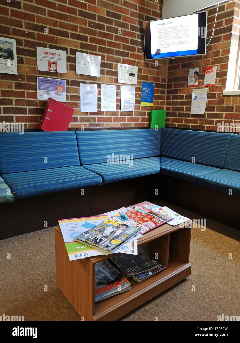 An empty waiting room & advice posters on the way seen in an NHS local ...