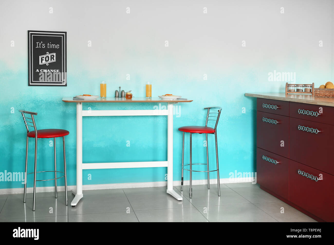 Modern light table with chairs in stylish kitchen Stock Photo - Alamy