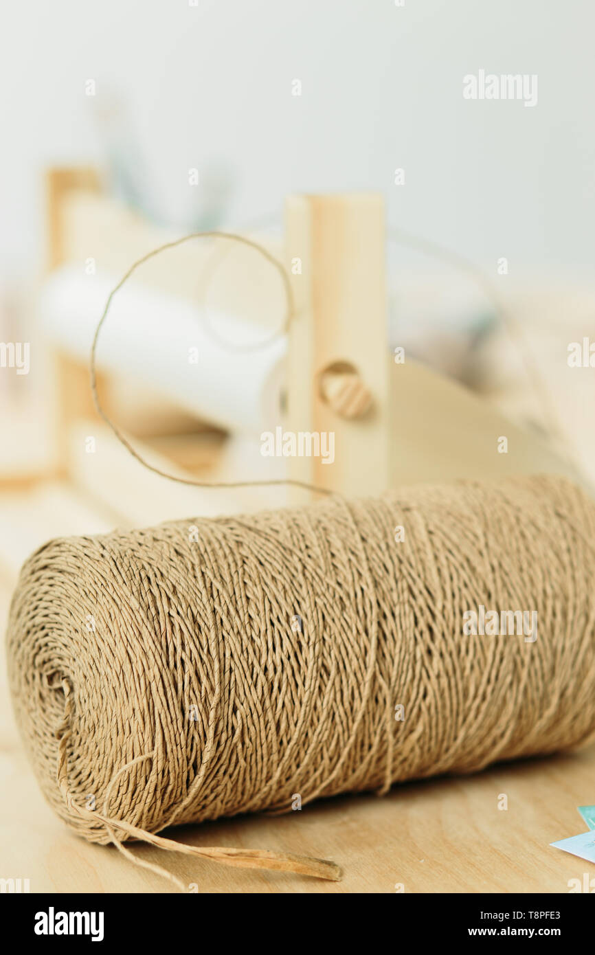 reel with string for gift wrapping on wooden table in a studio Stock ...