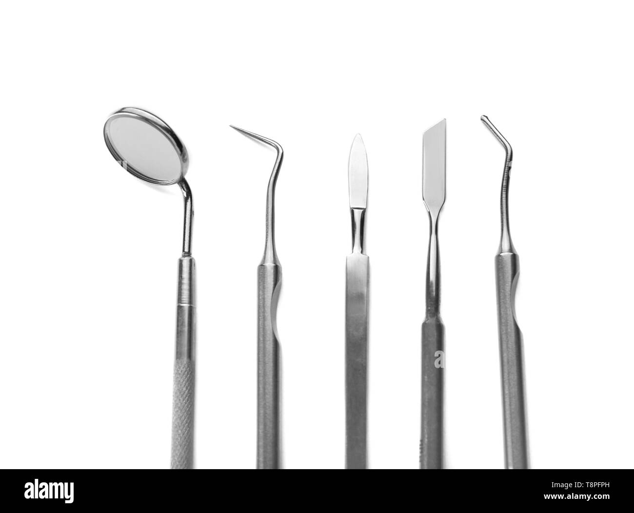 Dentist's tools on white background Stock Photo - Alamy