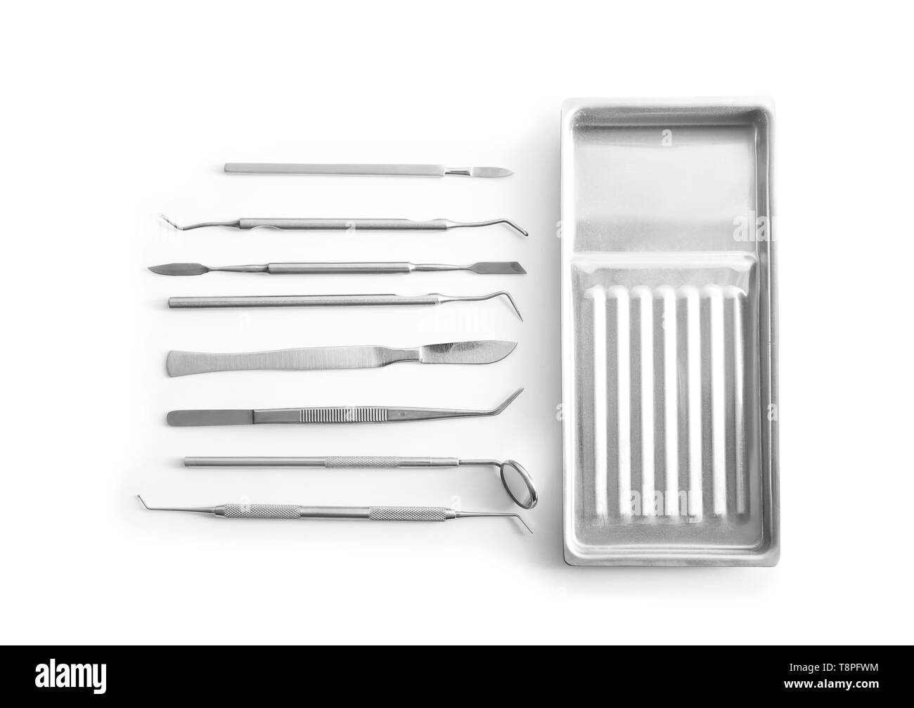 Dentist's tools and metal tray on white background Stock Photo - Alamy