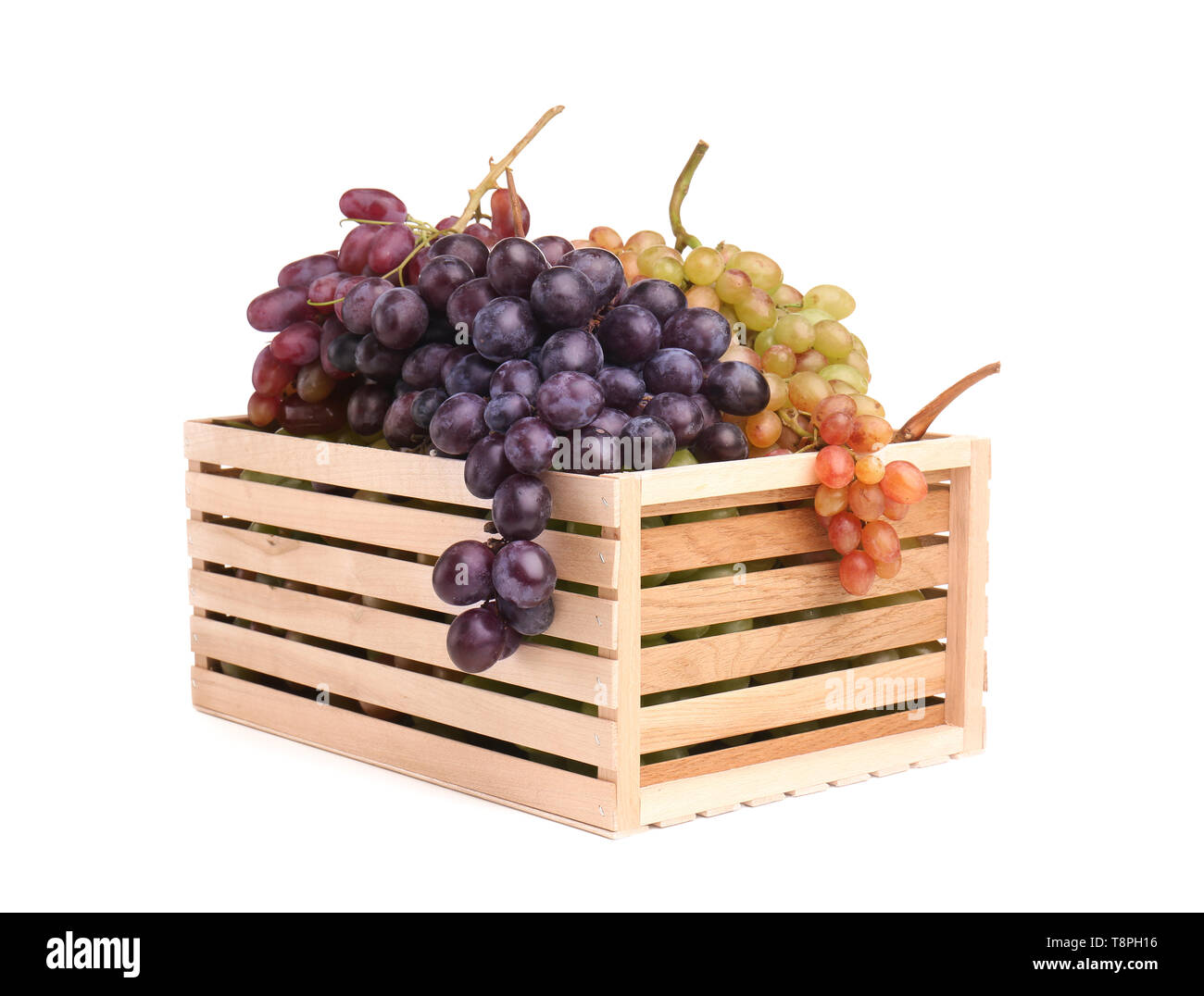 Wooden crate with different types of sweet grapes on white background ...