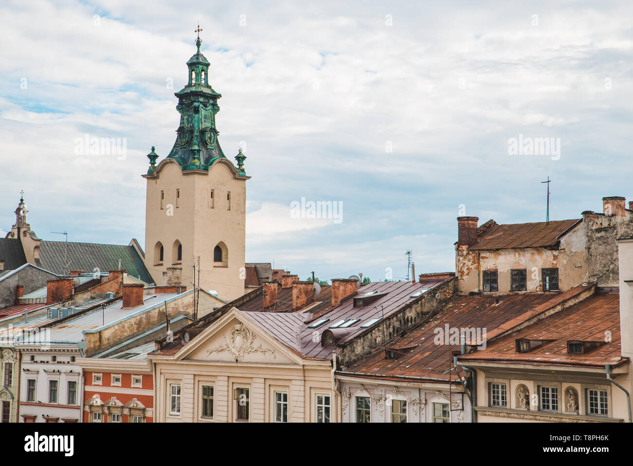 church tower over old building roofs. overcast weather. copy space ...
