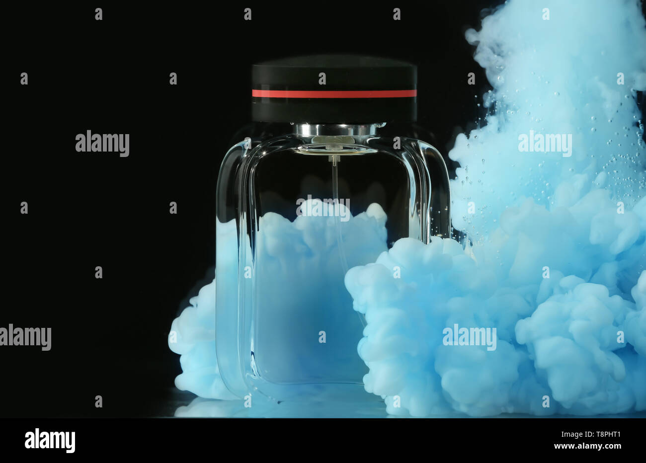 Bottle of perfume in color smoke on dark background Stock Photo - Alamy