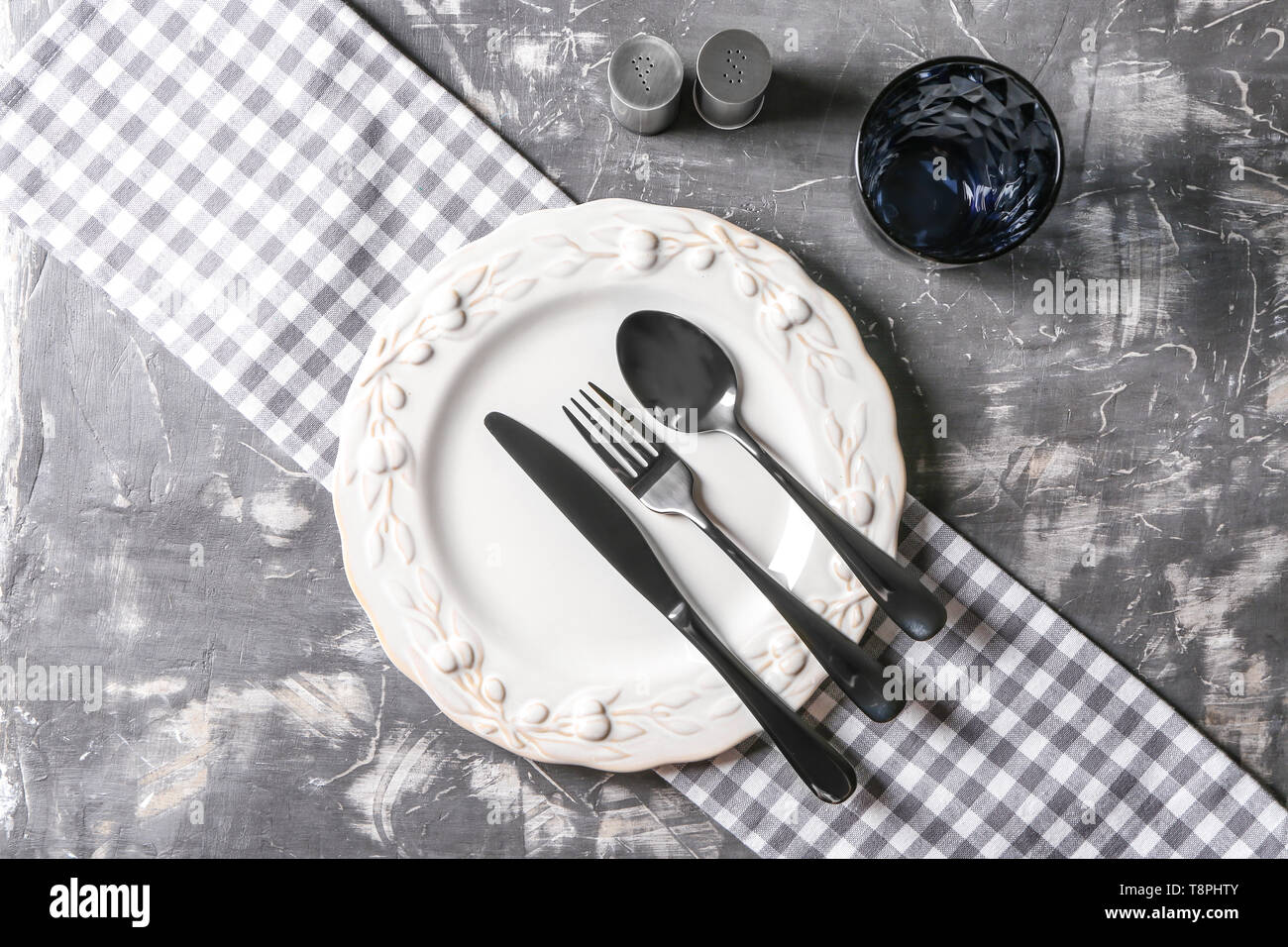 Set of cutlery on plate, top view Stock Photo - Alamy