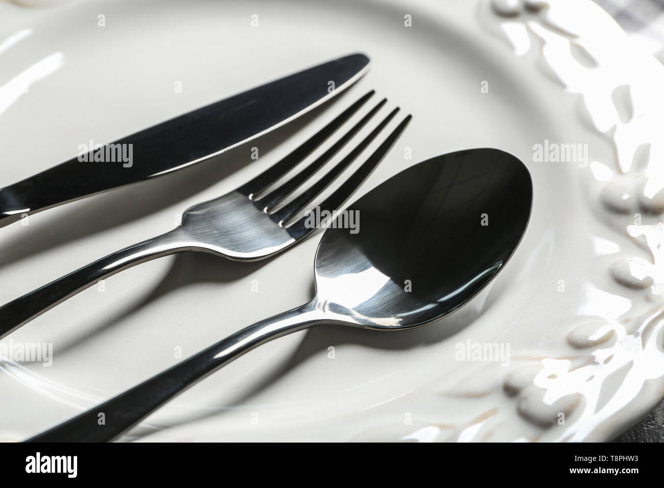 Set of cutlery on plate, closeup Stock Photo - Alamy